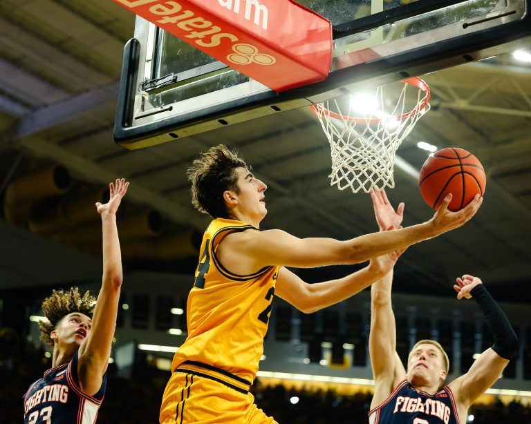 No. 16 Illinois hangs on to defeat No. 19 Iowa 75-69 before near ...